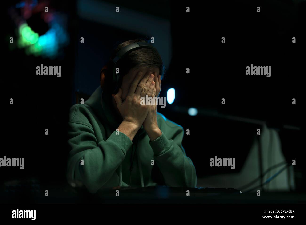 Stressed male cybersport gamer playing video game and praying with hope ...