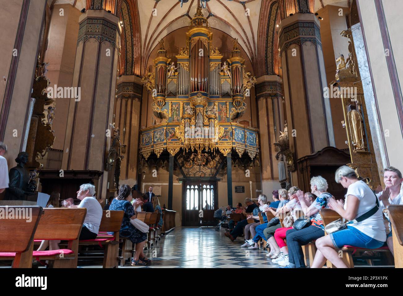 Visitors in cathedral listening to organs concert. Classified in the ...