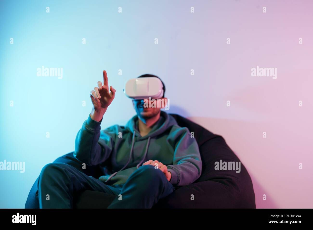 Man interacting with virtual object while using VR goggles Stock Photo ...