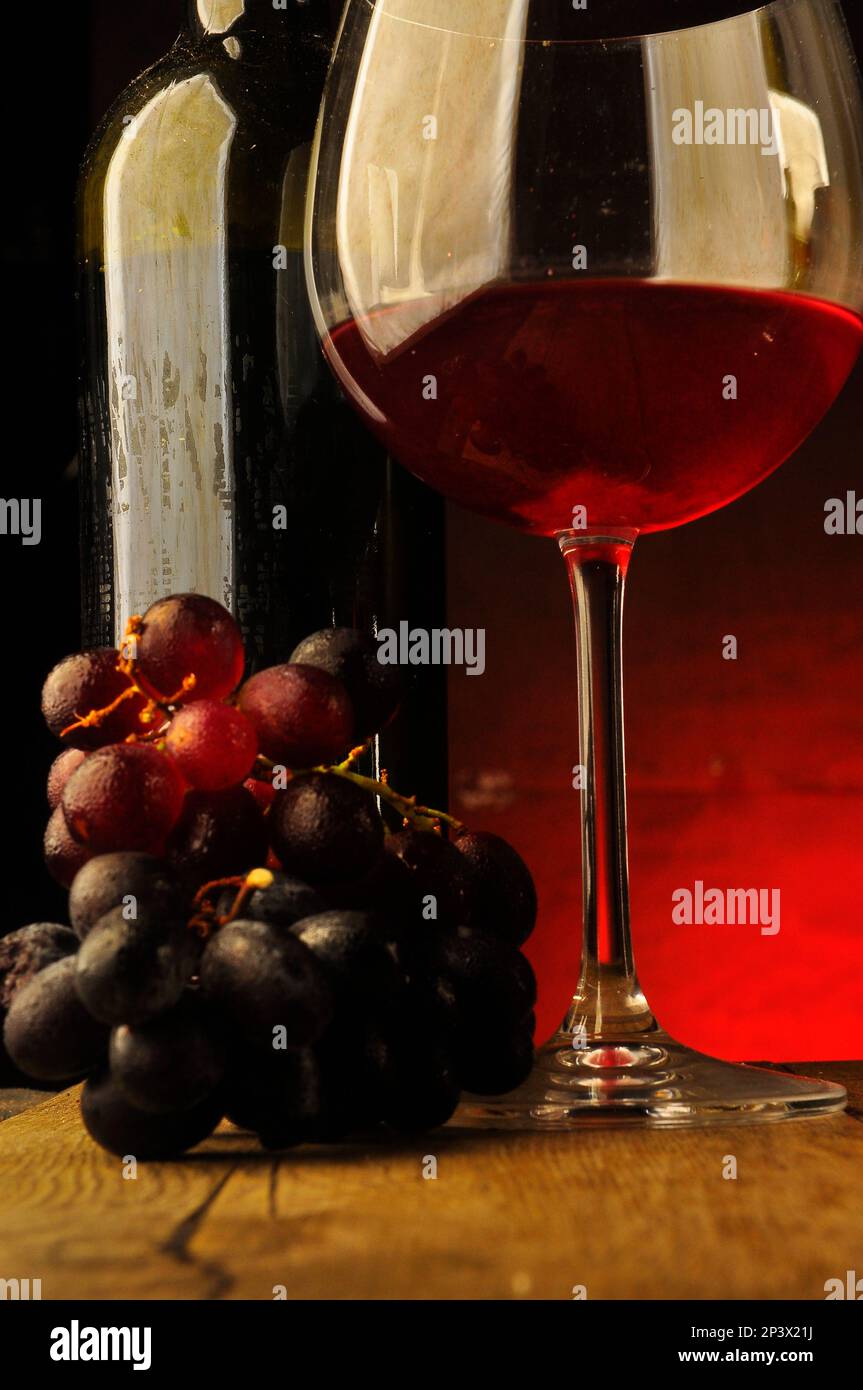 Glass and bottle of wine on the table Stock Photo - Alamy