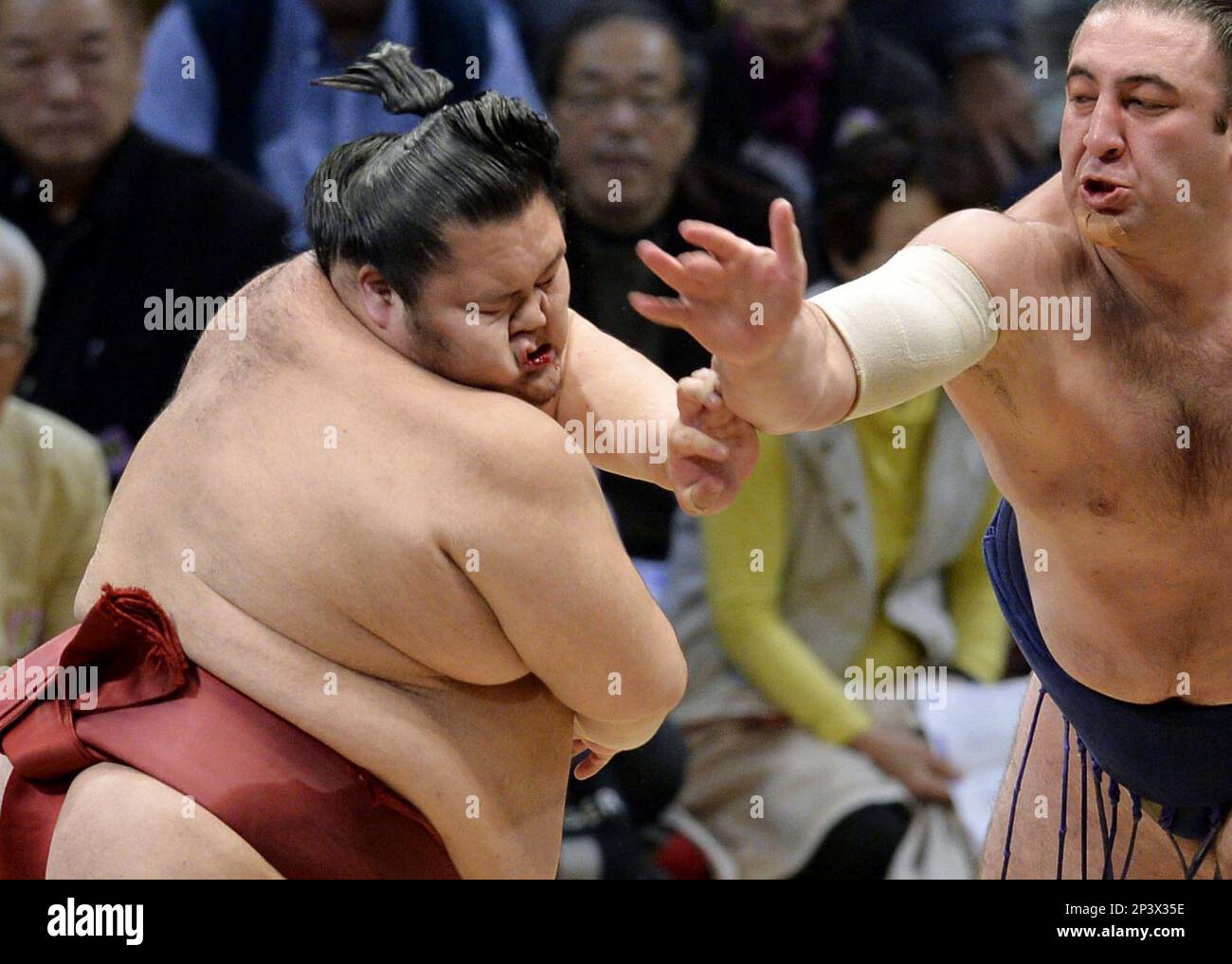 Sumo wrestler Chiyomaru, left, gets a slap on his face from Georgian-born Tochinoshin at the ...