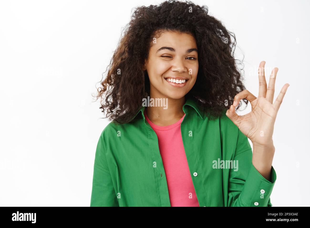 Perfect, no problem. Happy smiling young curly woman, shows zero, okay ...