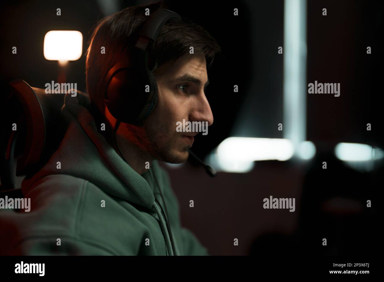 Focused male gamer in headphones playing computer game Stock Photo - Alamy