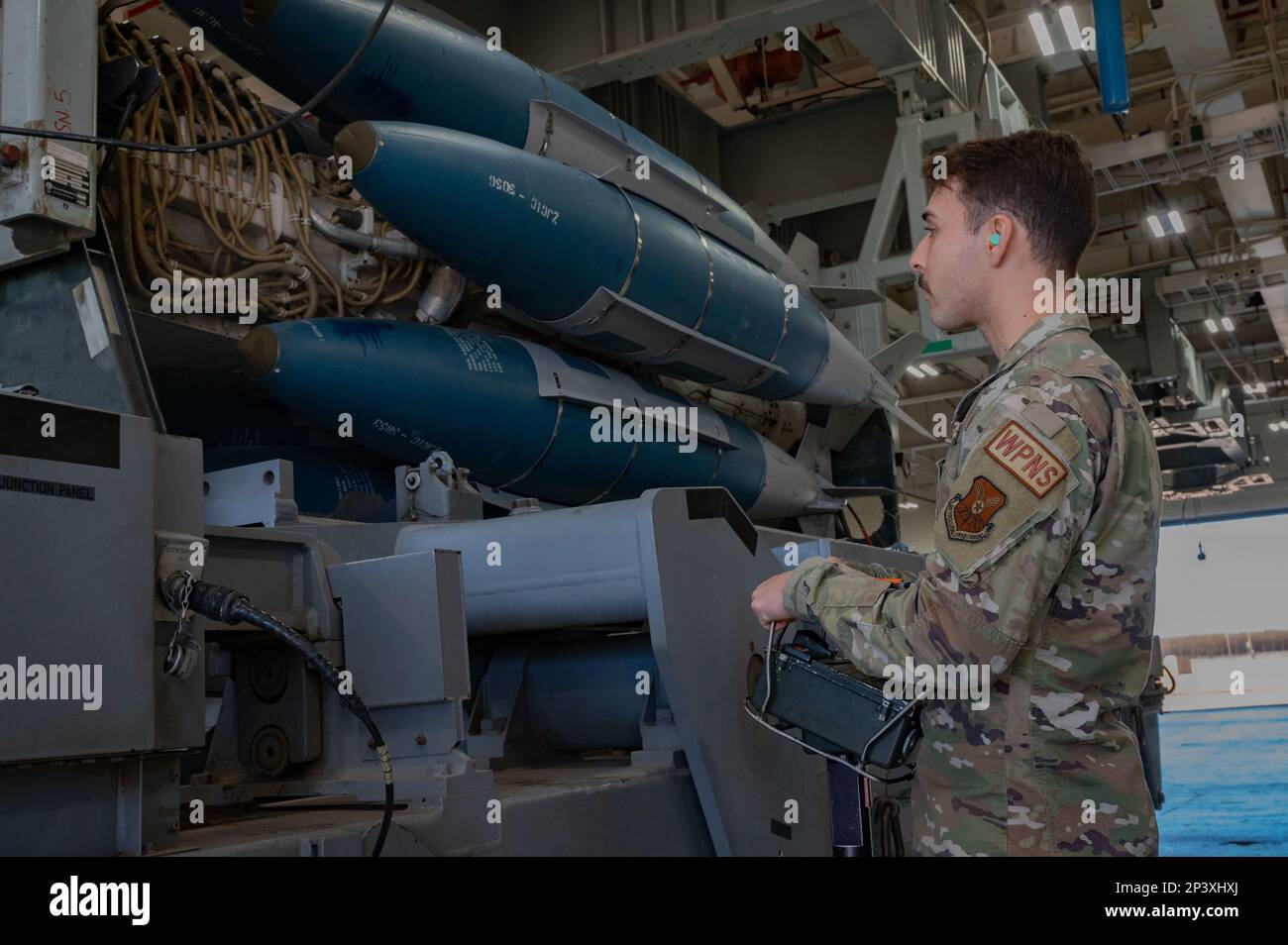 A 7th Aircraft Maintenance Squadron weapons load crew member lowers the ...