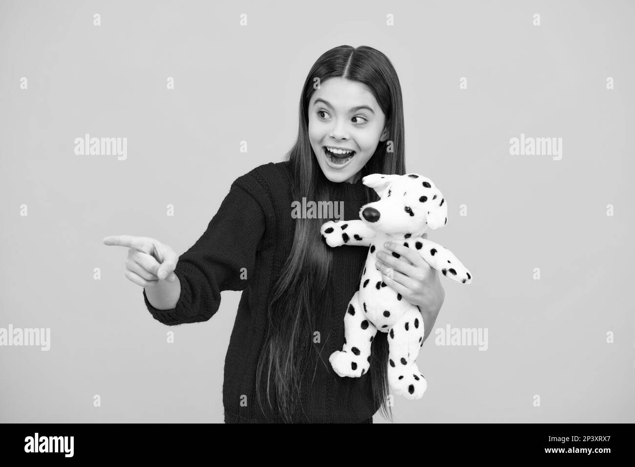 Excited face. Childhood, toys and kids. Cute teen girl cuddling fluffy ...