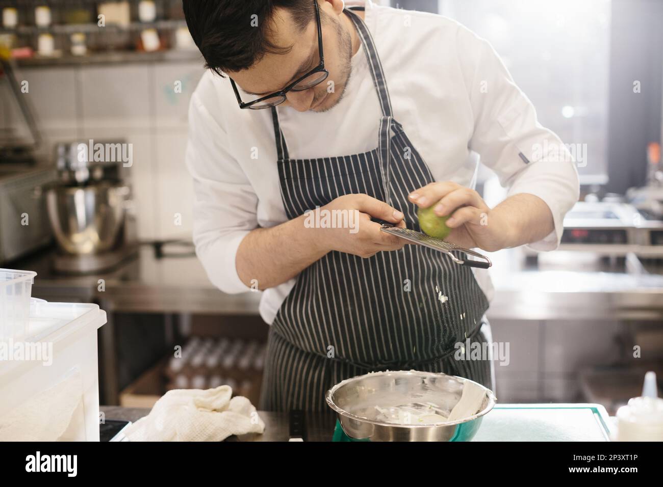 The middle section is a portrait of a chef grating lime zest. The ...