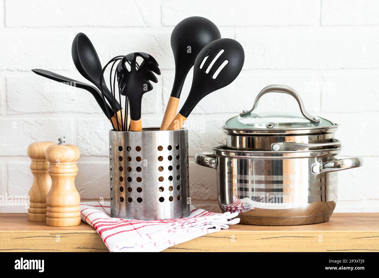 Modern Kitchen with wooden table, kitchen utensils, cooking pots at ...