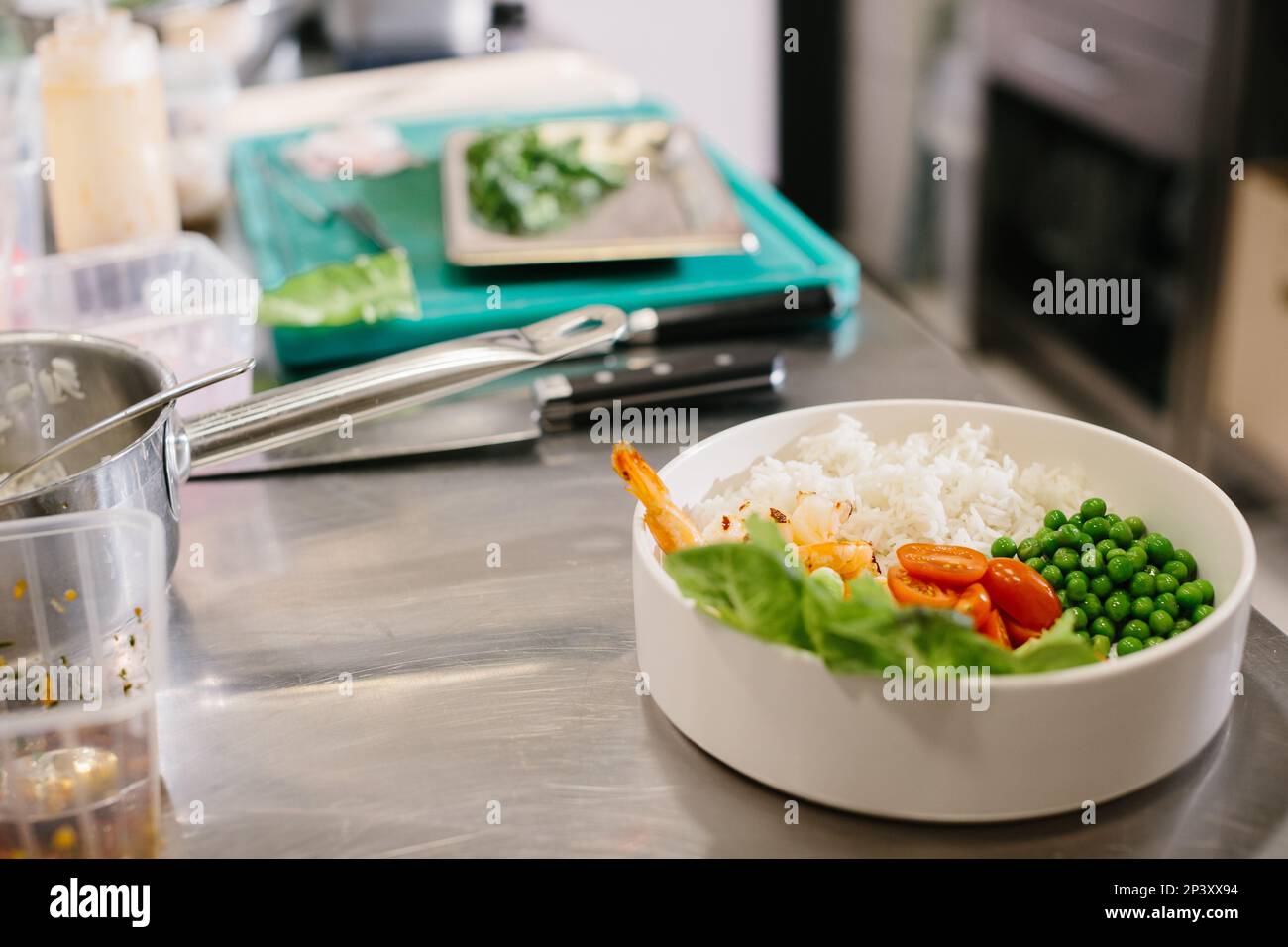 Preparing a bowl of seafood, a male chef prepares a delicious dish in a ...