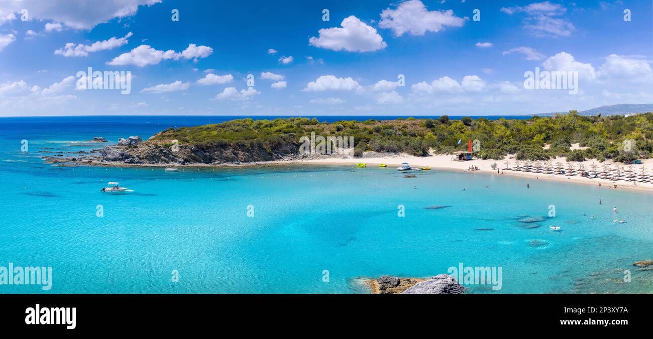 Crystal clear turquoise water in a Glystra beach. Cane umbrellas and ...