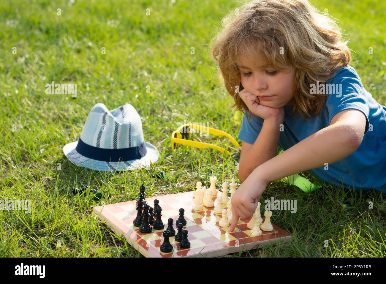 Chess game for kids. Child playing chess Stock Photo - Alamy