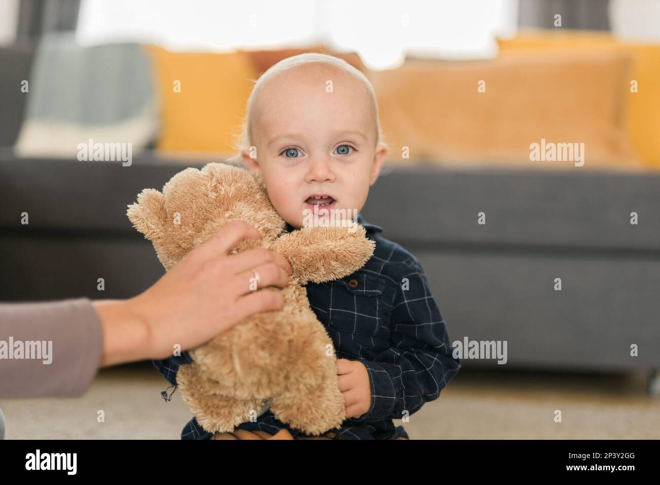 Happy toddler boy playing with her teddy bear at house - childhood and ...