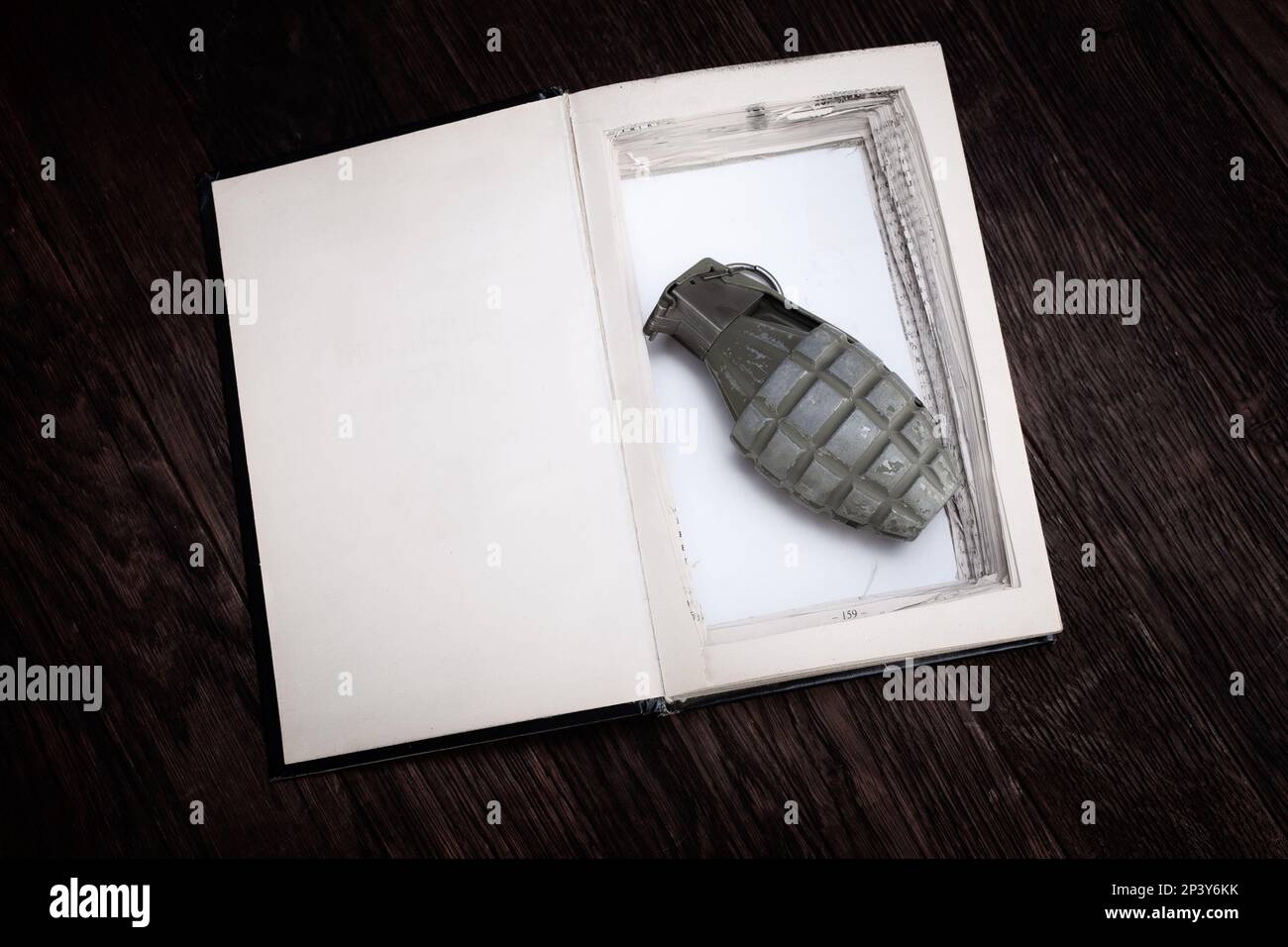 hand grenade hidden in a book Stock Photo - Alamy