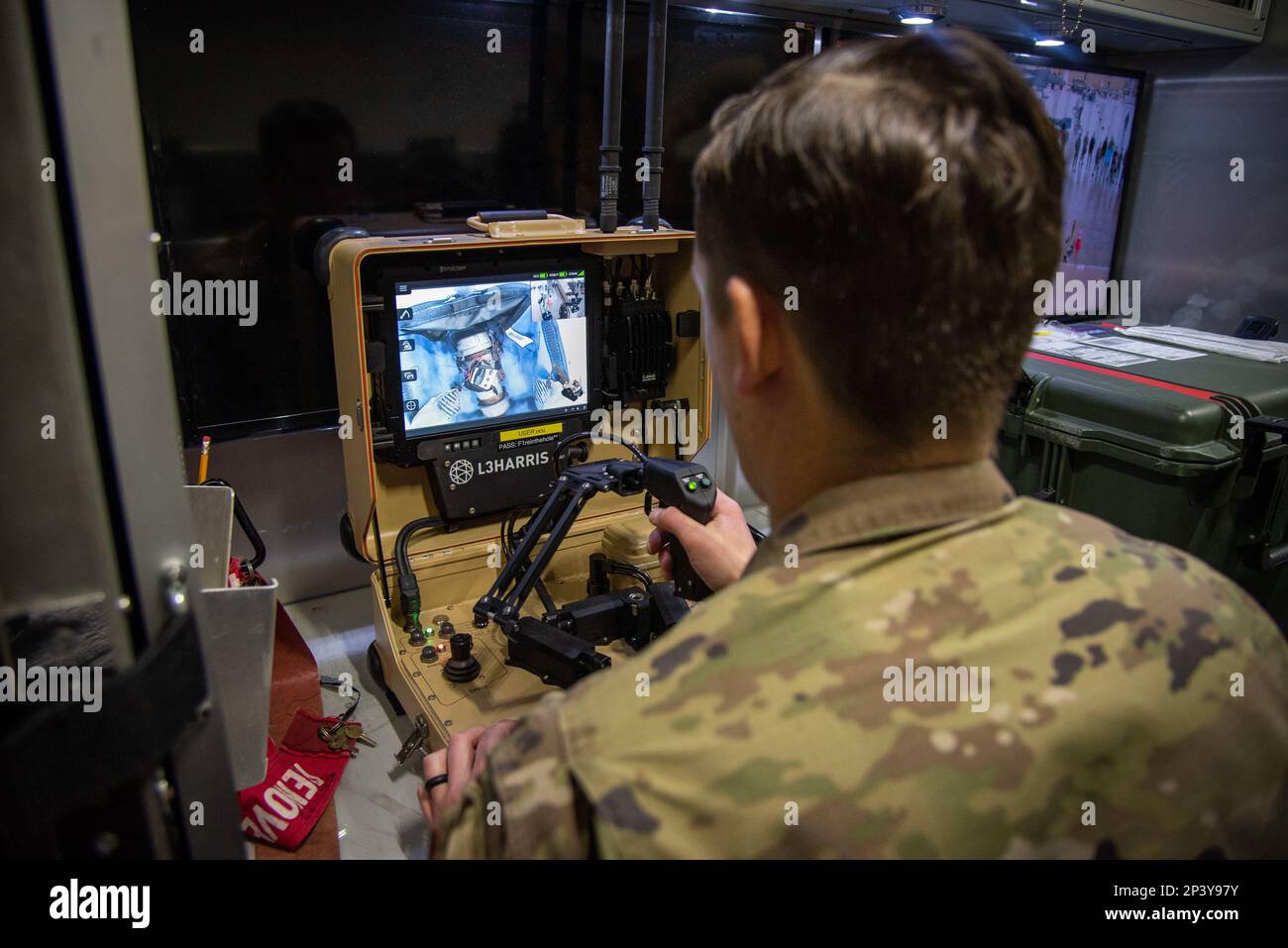 Senior Airman Devin Beedle operates the T7 robot during a demonstration ...
