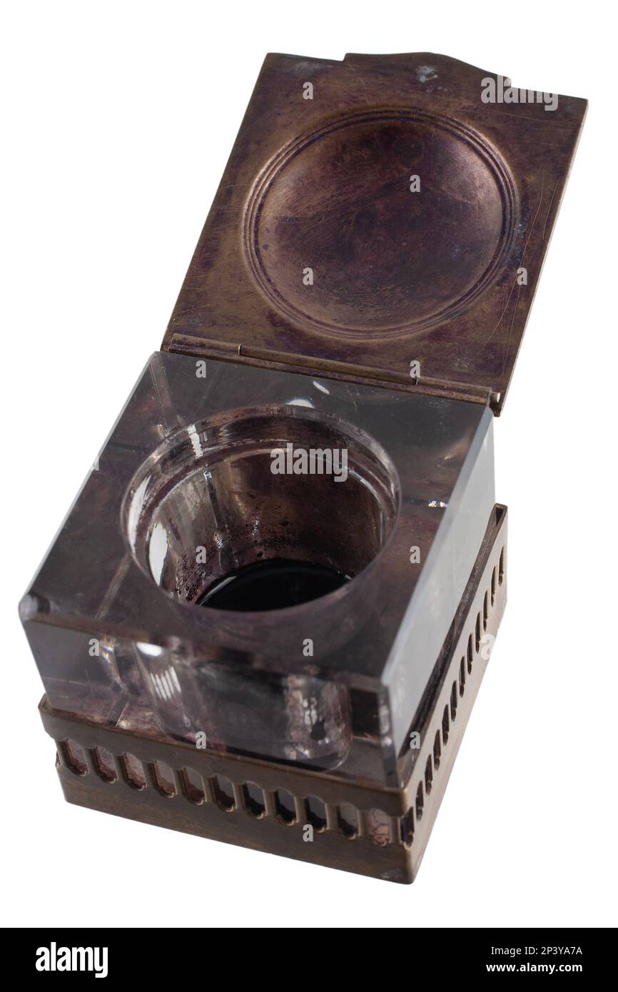 Old vintage glass inkwell with black ink isolated on white background ...