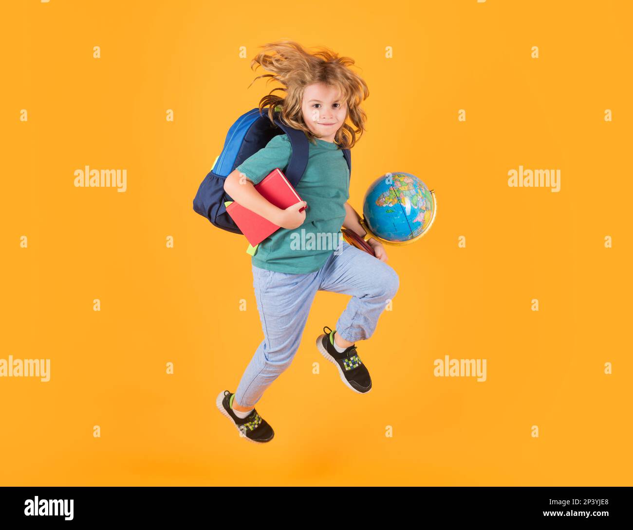 Full length of excited kid jumping. Back to school. School child in ...