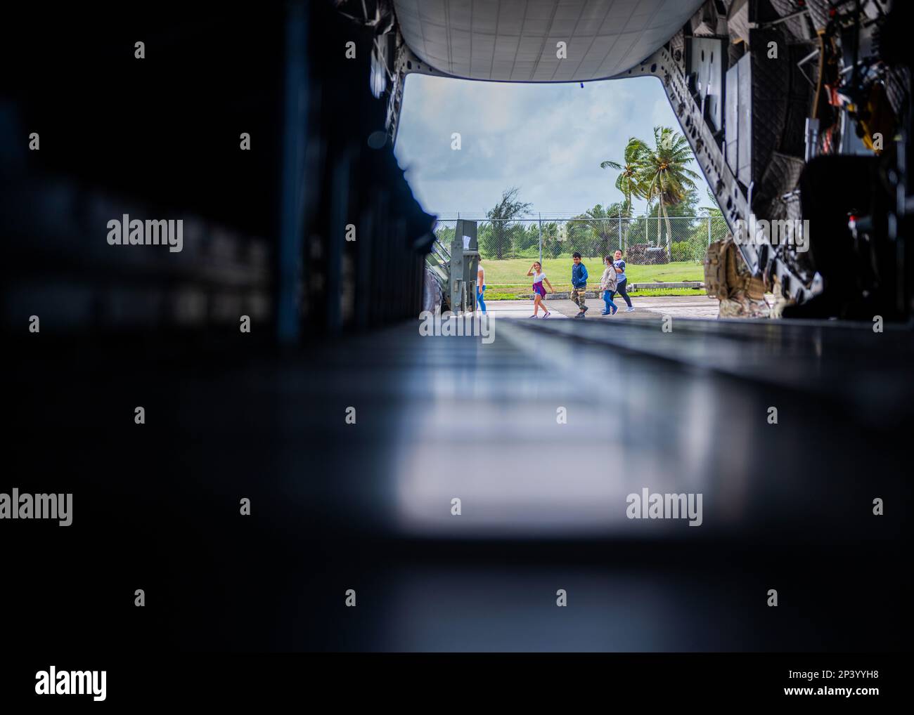 Children approach a C-27 Spartan at a community engagement event during ...