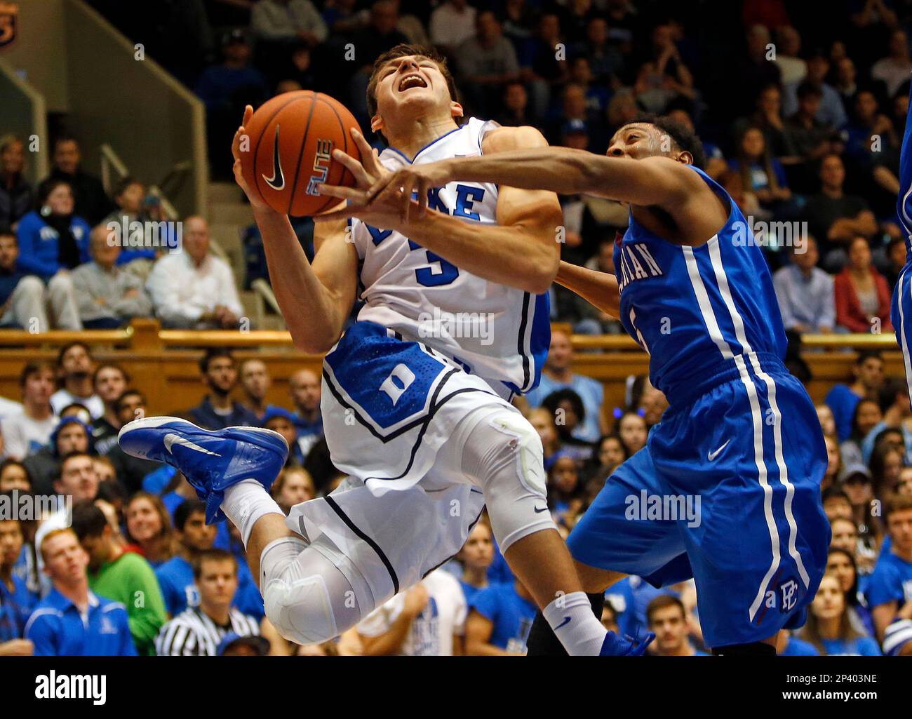 Duke's Grayson Allen, left, drives the ball into Presbyterian's Davon ...