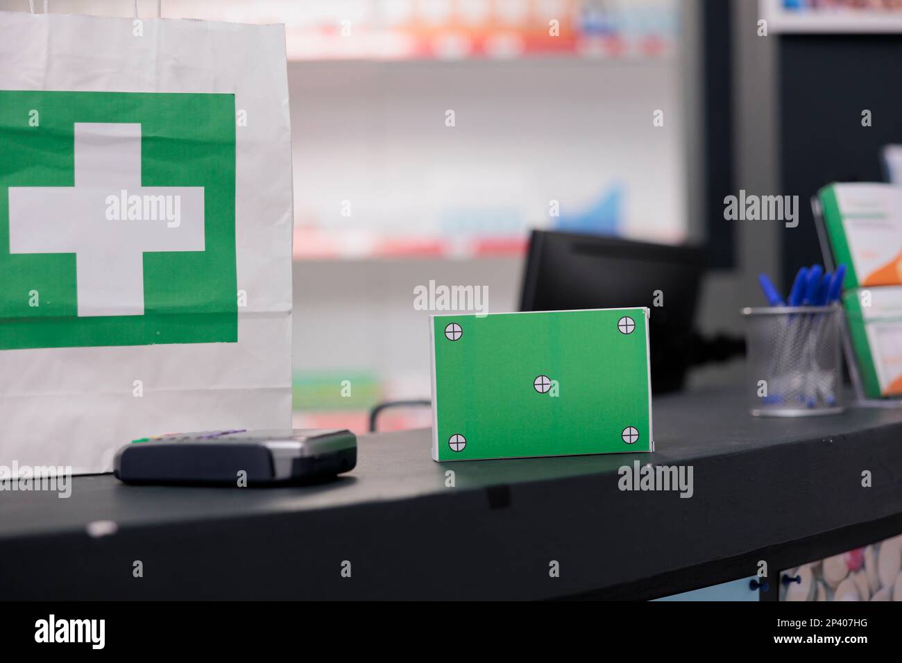 Green screen mock up chroma key pills packages standing on drugstore counter desk in empty ...