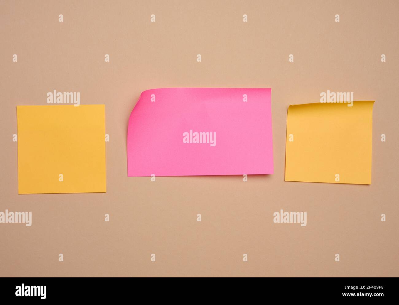 Multi-colored paper stickers for notes on a beige background, a place ...