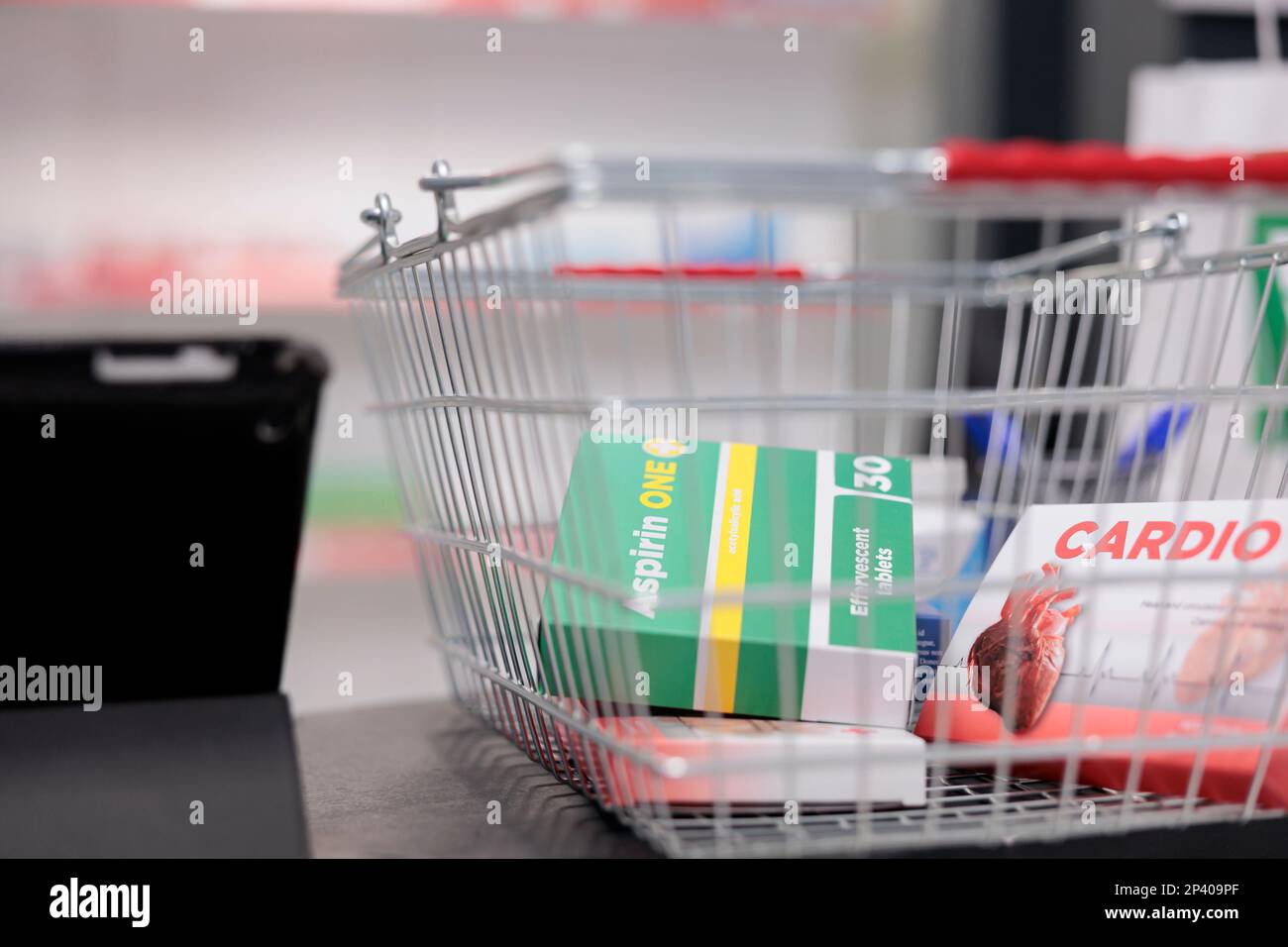 Store shopping basket filled with pharmaceutical products standing on ...