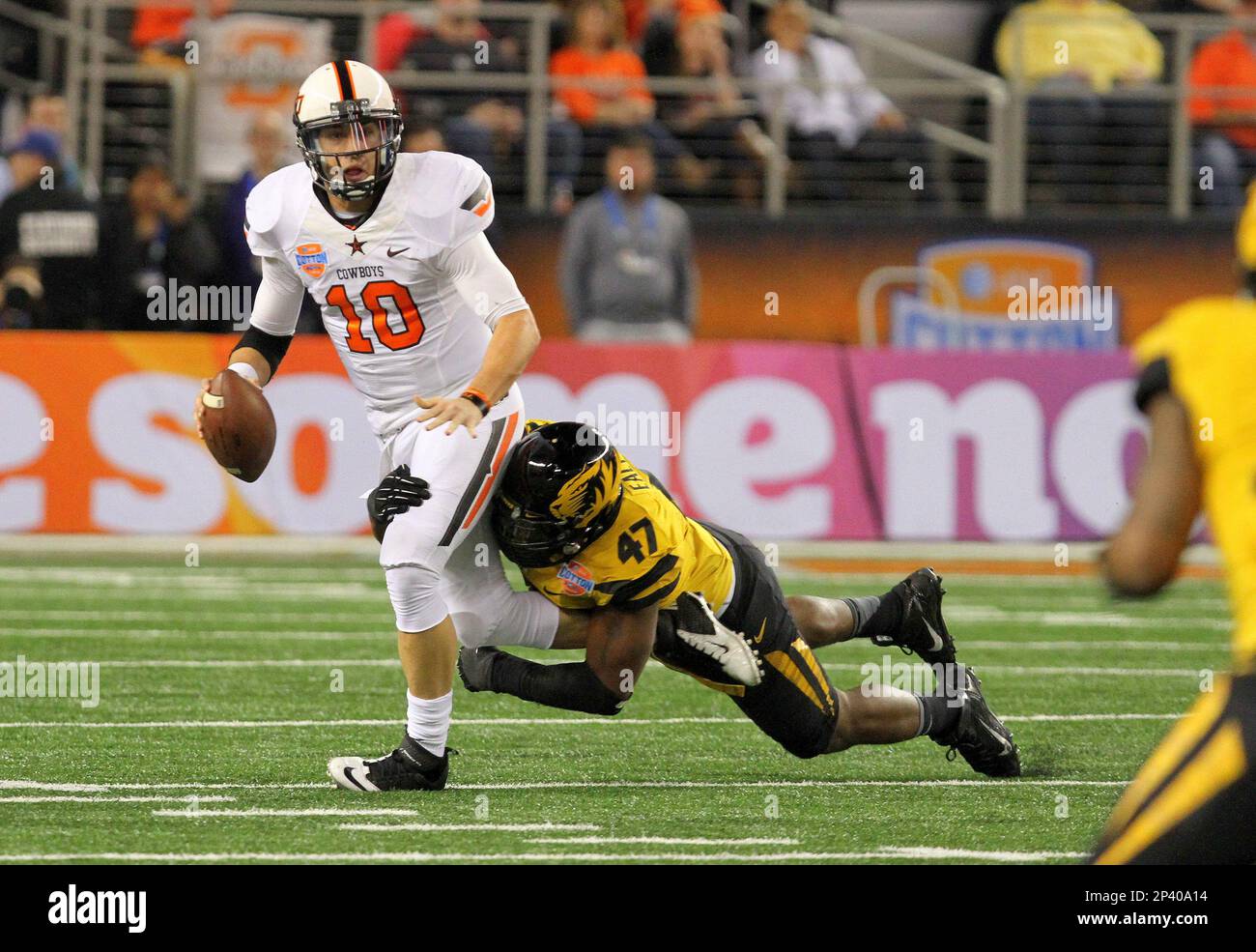 3 January 2014 - Oklahoma State quarterback Clint Chelf (#10) is sacked ...