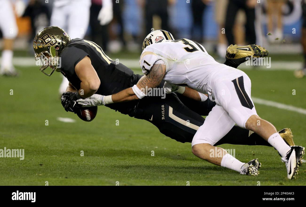01 January 2014: Baylor's Jordan Najvar is hit by UCF's Sean Maag ...