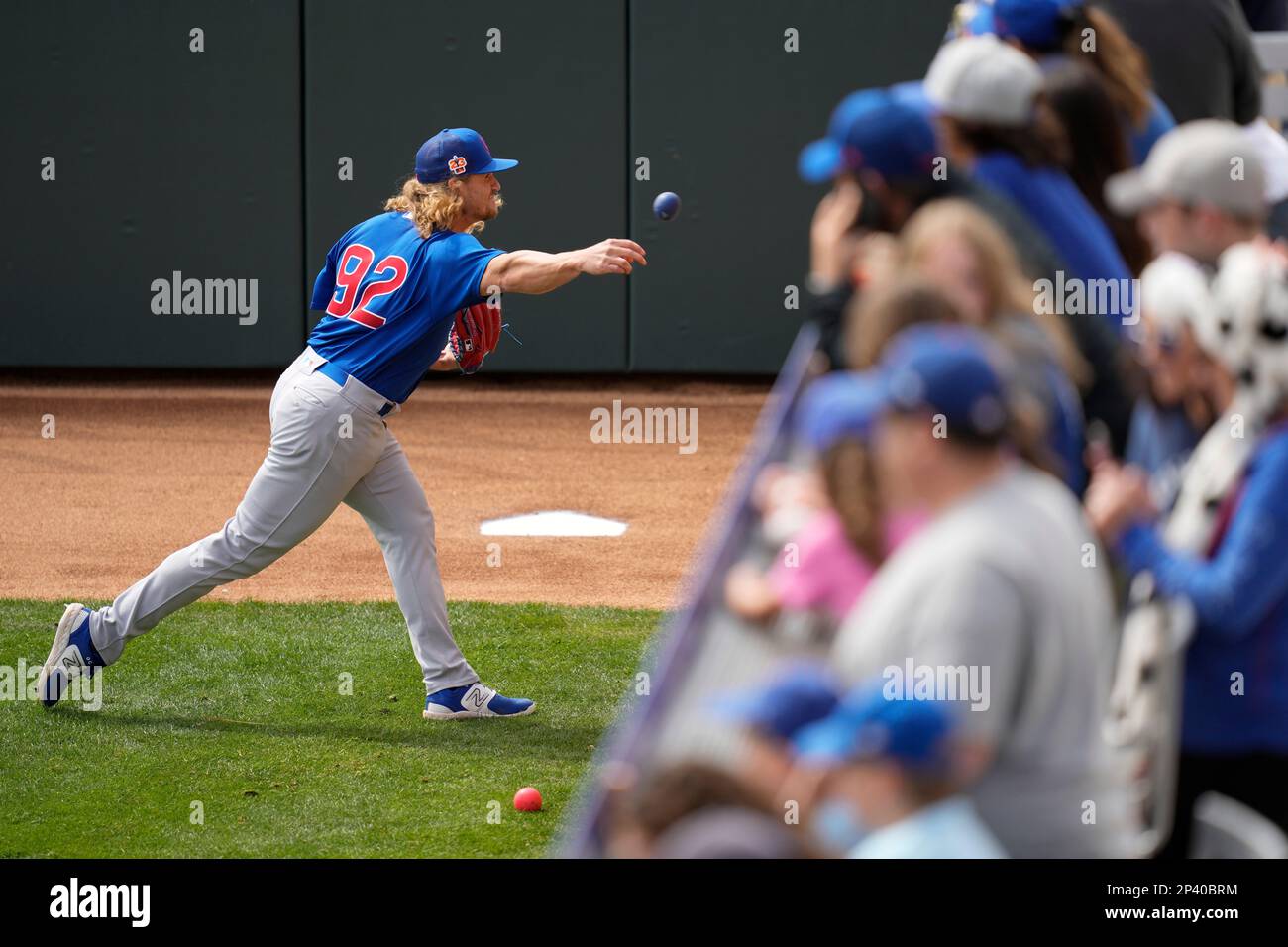 Fans watch as Chicago Cubs relief pitcher Bailey Horn warms up before a ...