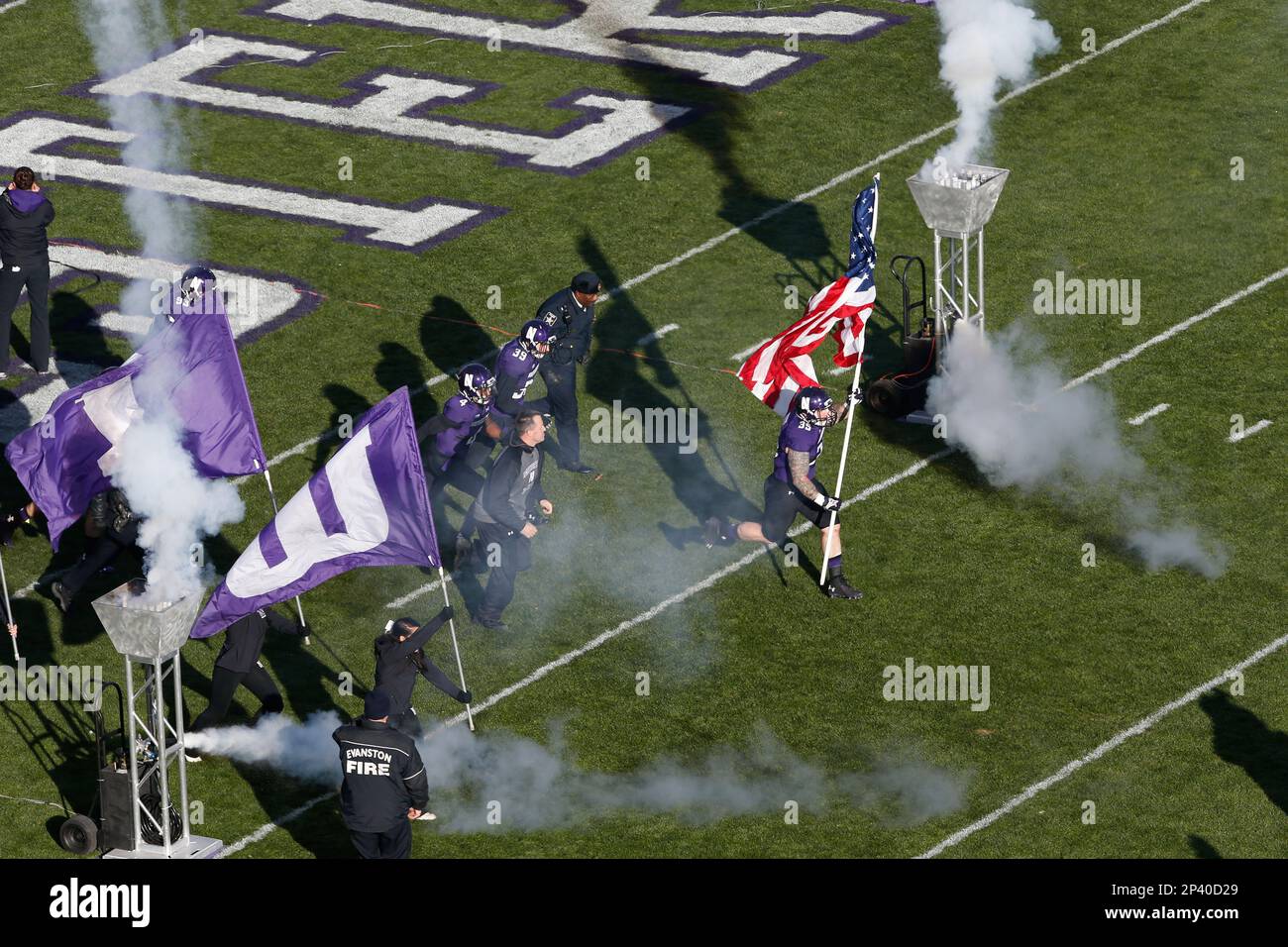 Northwestern defensive lineman Tom Hruby (35) carries an American Flag ...