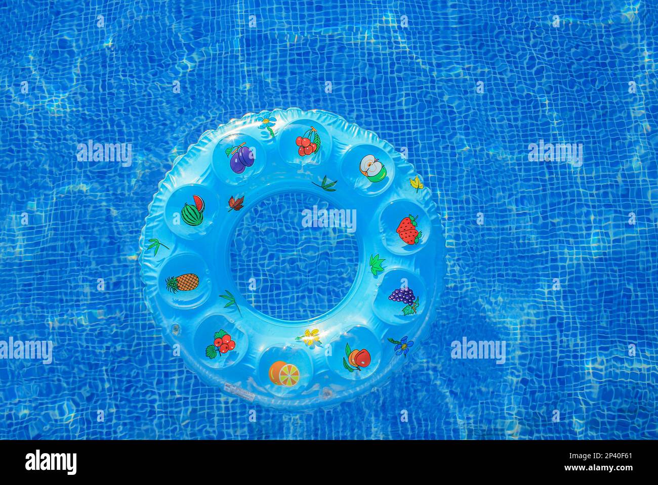 Colorful inflatable ring donut toy in swimming pool water aerial view ...