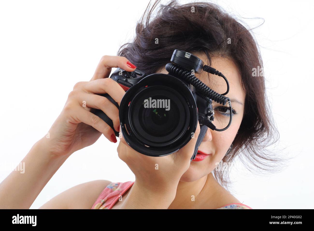 beautiful young woman with a DSLR professional camera on white ...