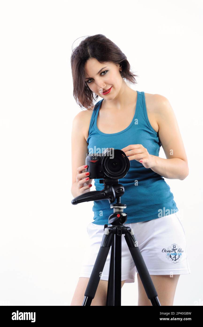 beautiful young woman with a DSLR professional camera on white ...