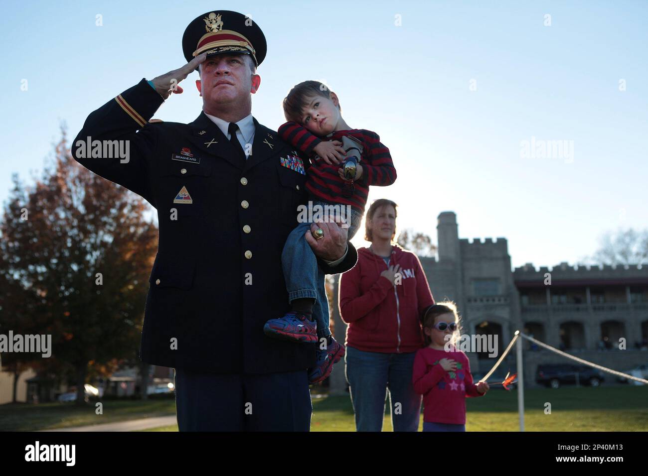 Thomas Brashears of Fairfield, Virginia, salutes with his family ...