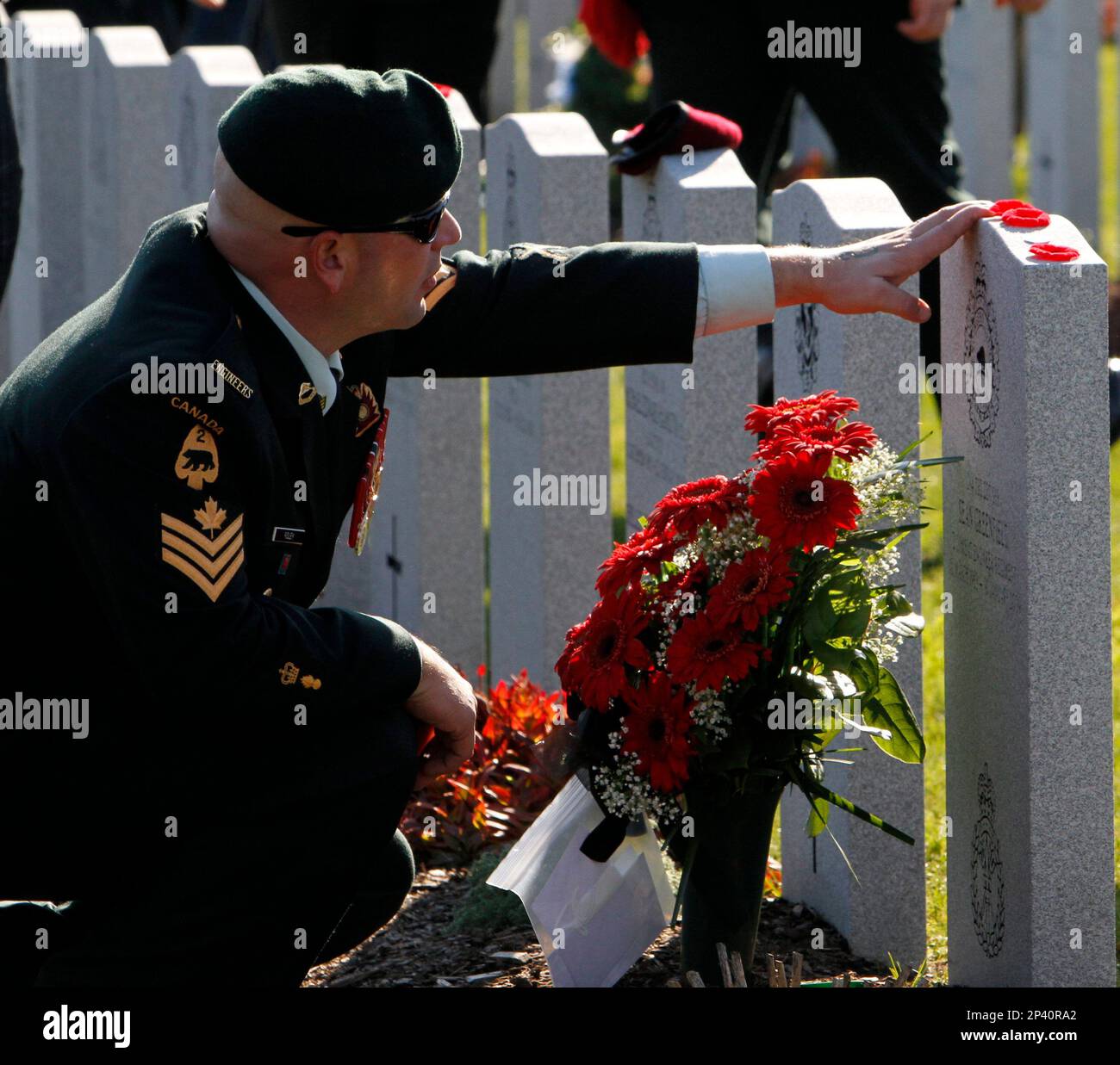 Sgt. Graham Ridley pays his respects to a fallen comrade and friend Spr ...