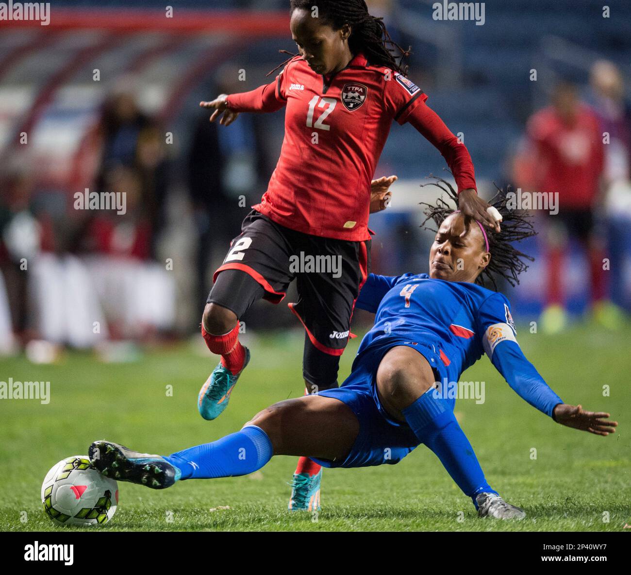 October 17, 2014: Haiti's Kencia Marseille (4) slide tackles Trinidad ...