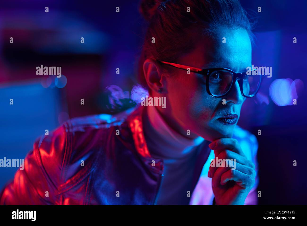 Neon metaverse futuristic concept. pensive stylish woman in glasses in ...