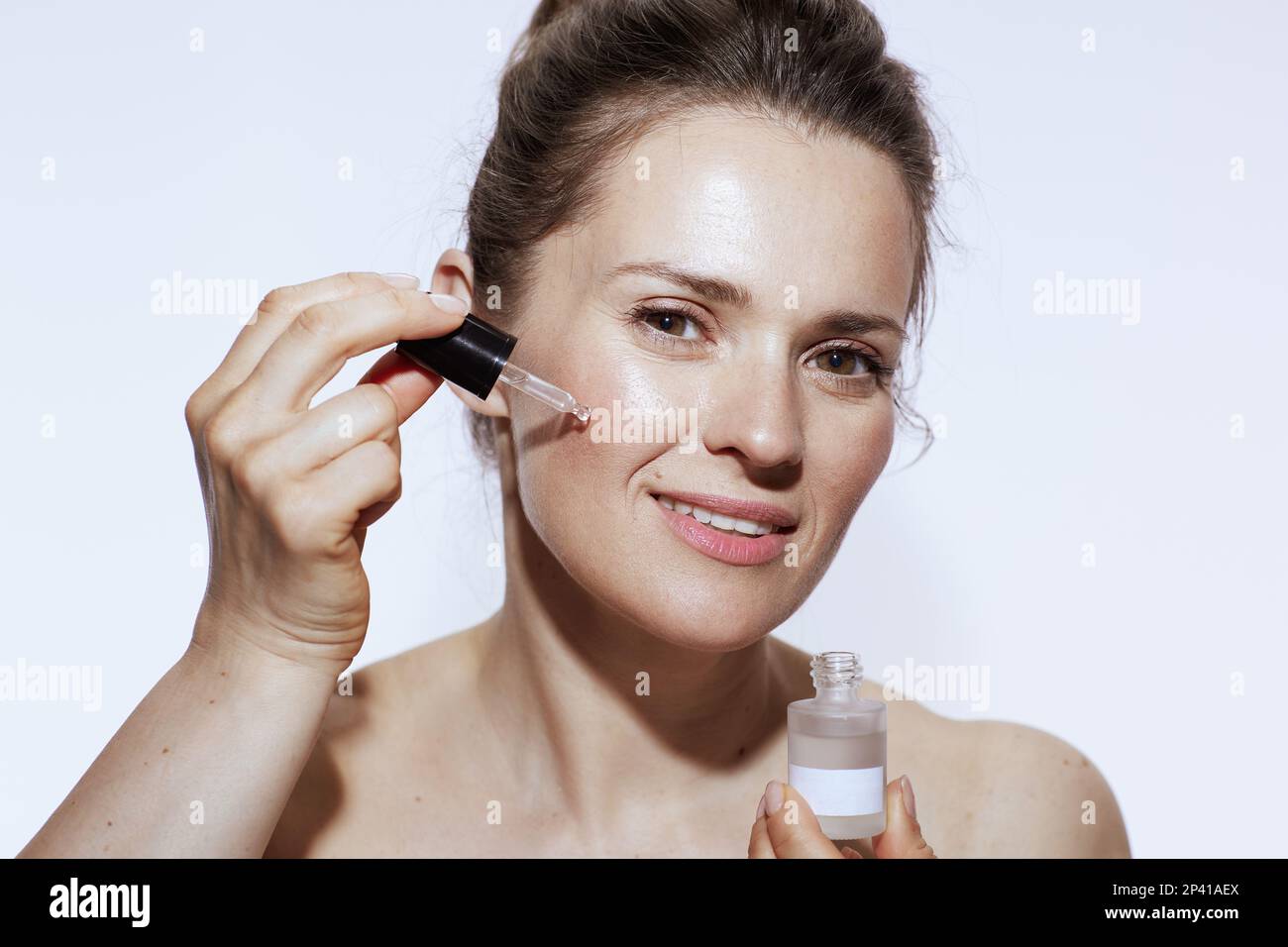 happy modern female with cosmetic elixir isolated on white background ...