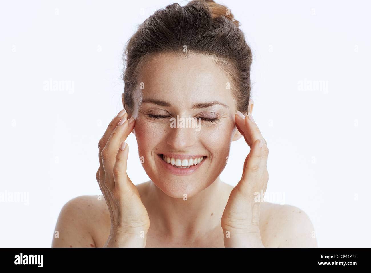 Happy Middle Aged Woman Doing Facial Massage Isolated On White 1506