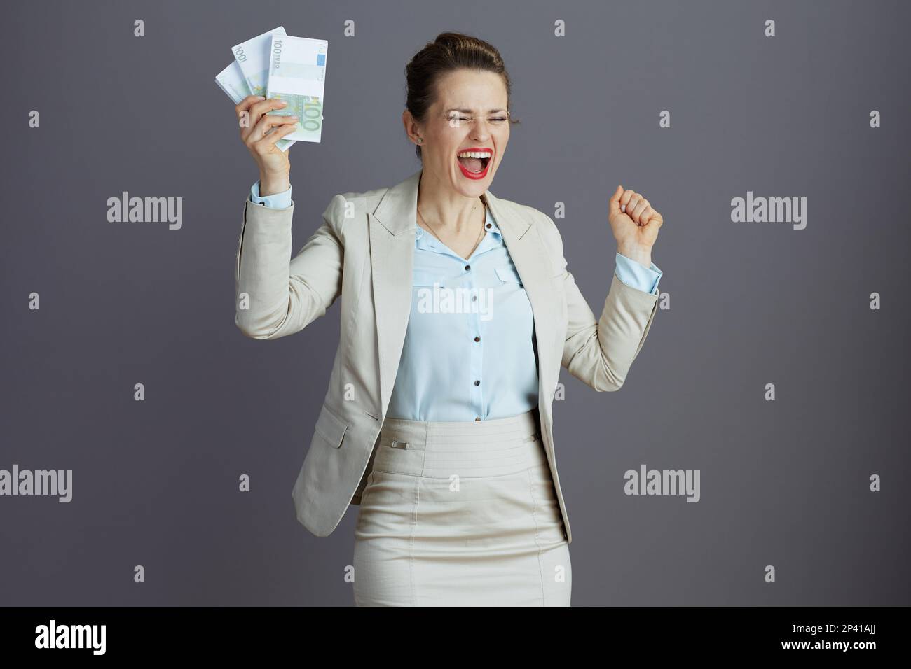 happy elegant small business owner woman in a light business suit with ...