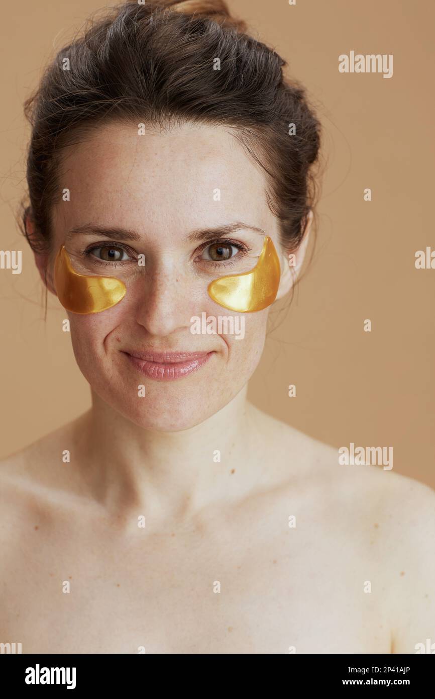 happy modern woman with eye patches isolated on beige background Stock ...