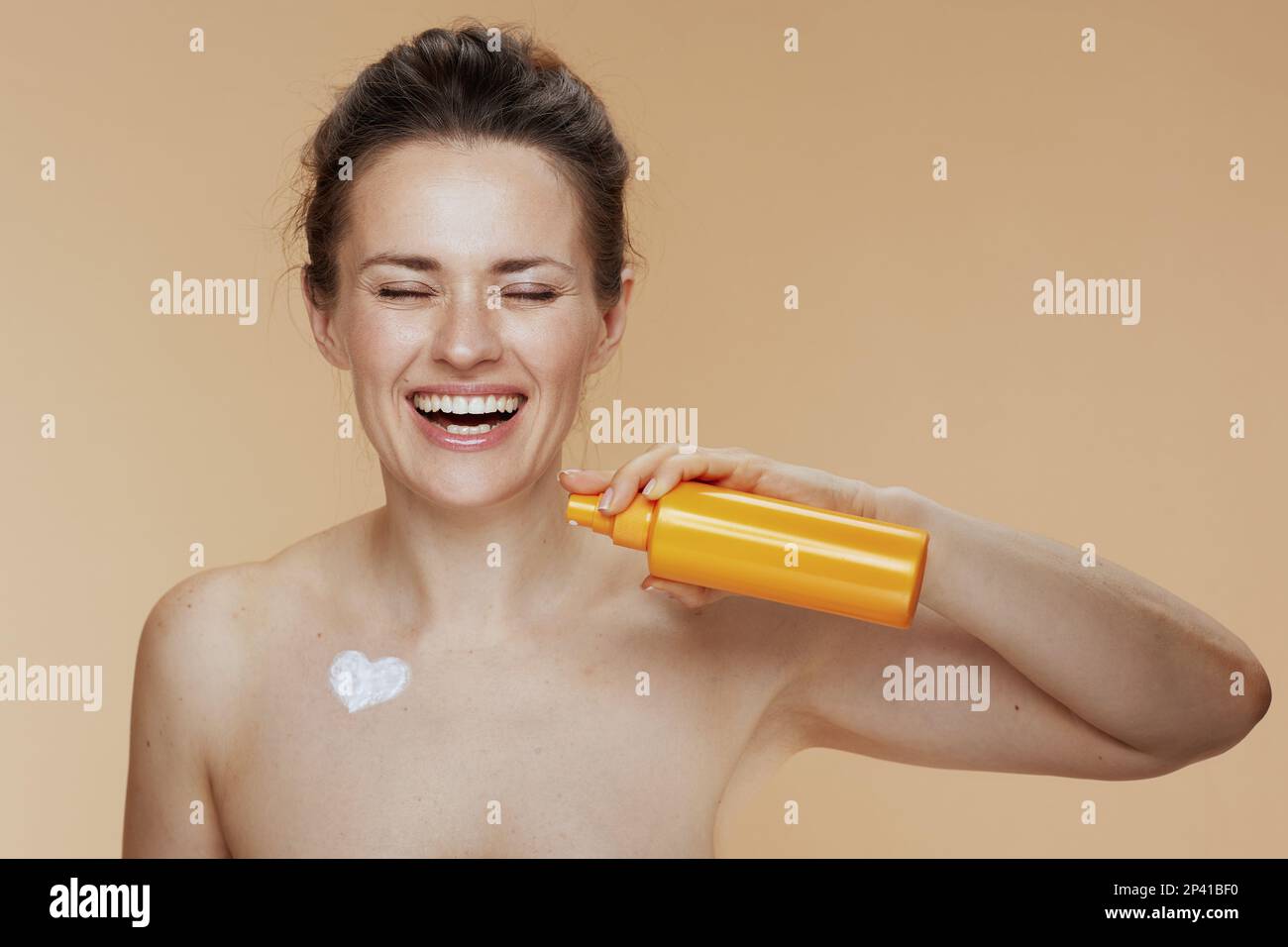 Smiling Modern 40 Years Old Woman With Cosmetic Cream Jar And Heart