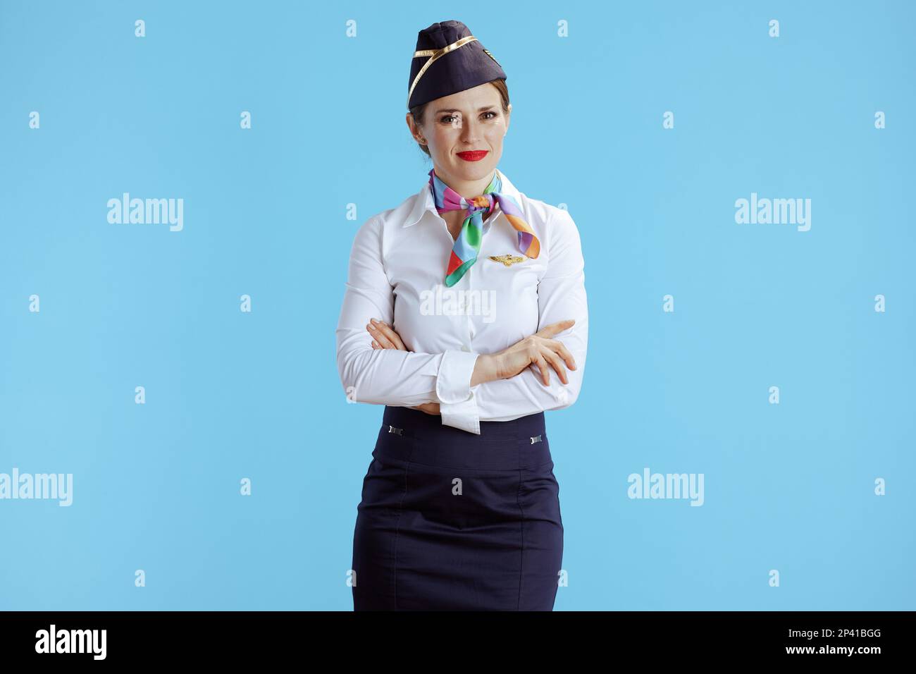 elegant air hostess woman against blue background in uniform Stock ...