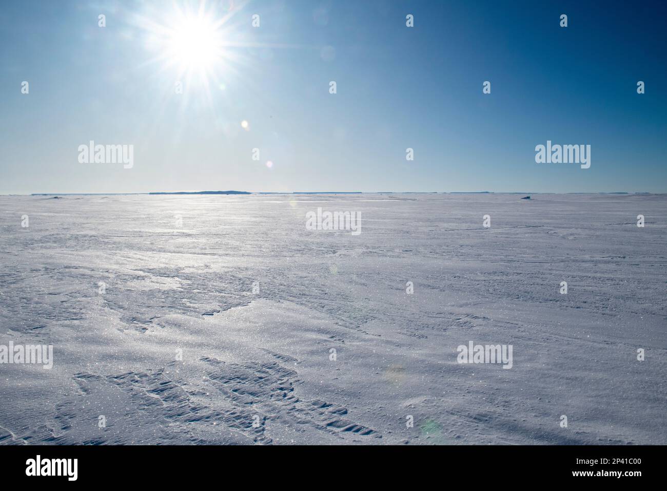 Antarctica, Amundsen Sea, Siple Island. Sunburst over frozen sea ice ...