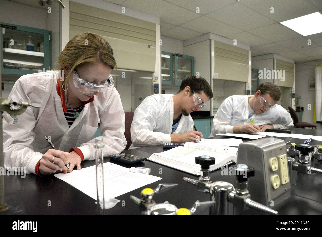 From left, Gretchen Gray, Christopher Reece and Devin Signs, work ...