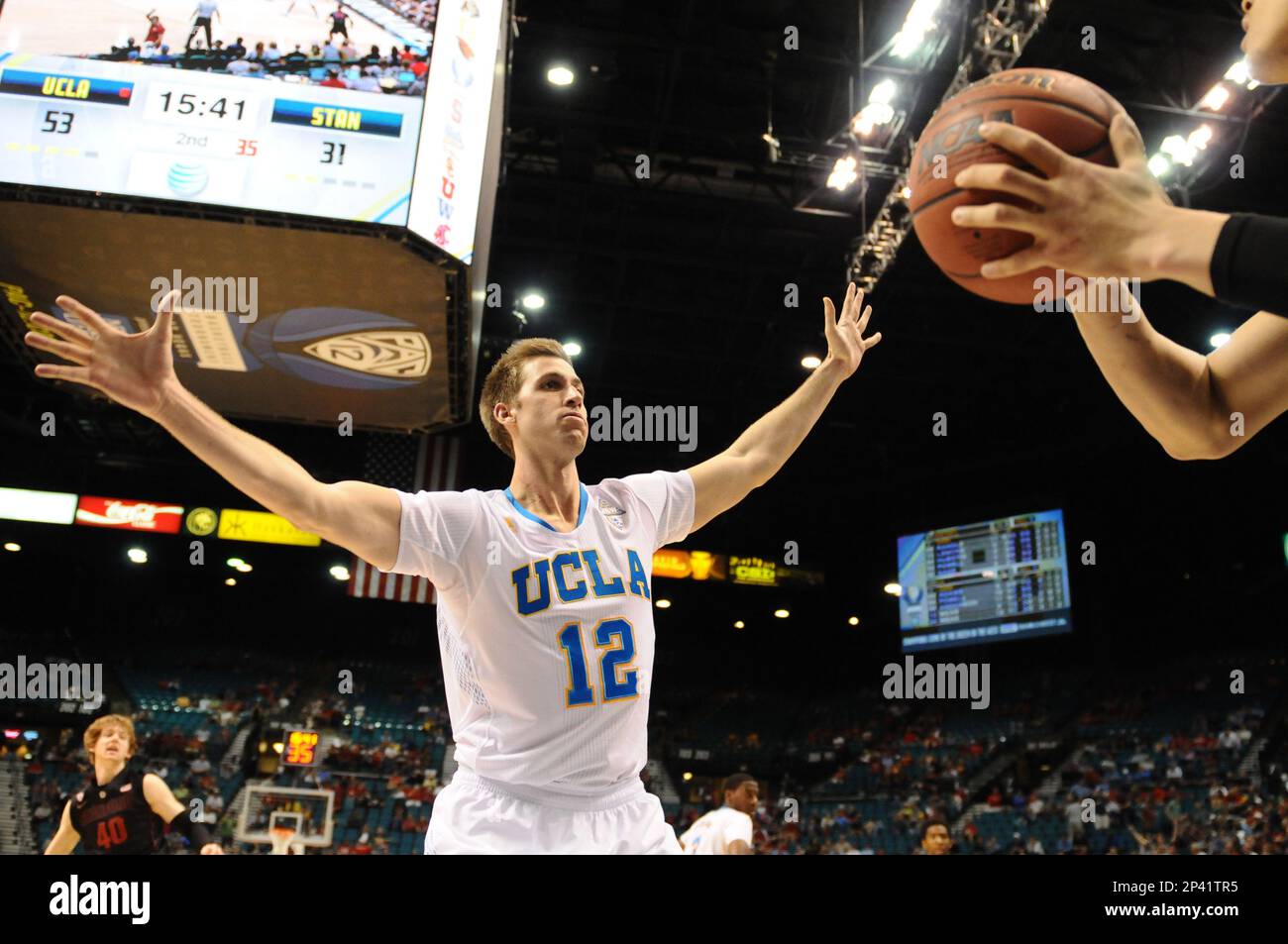 14 March 2014: UCLA (12) David Wear guards the in bound by Stanford (33 ...