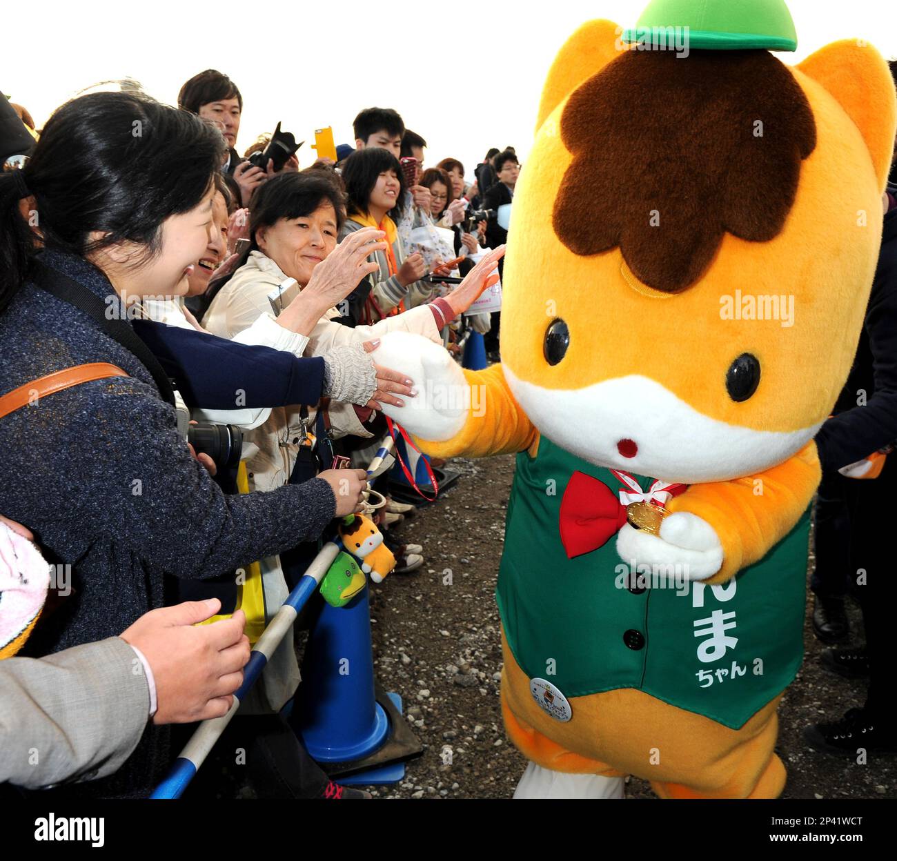 Gunma-chan (R), a moscot of Gunma Prefecture shakes hands with ...