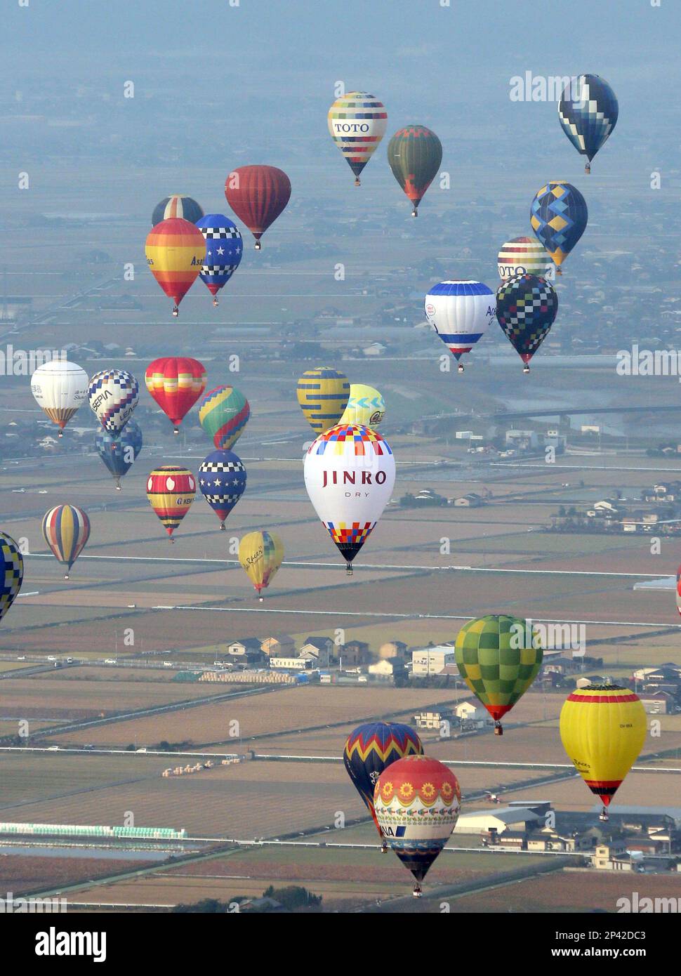 Colorful hot-ari balloons are floating in the air in the 2014 Saga International Balloon Fiesta ...