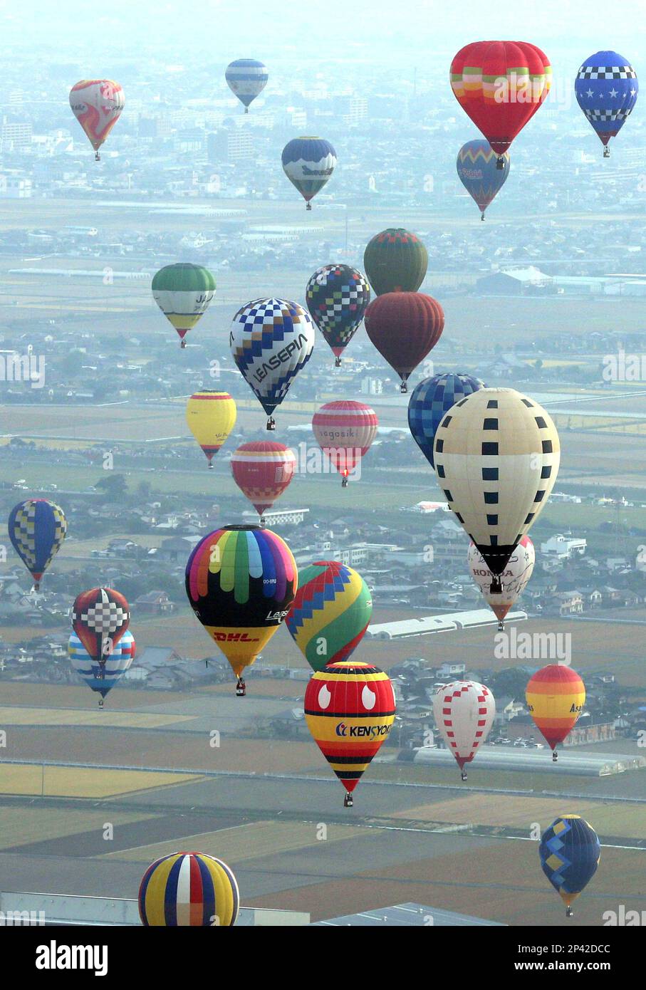 Colorful hot-ari balloons are floating in the air in the 2014 Saga International Balloon Fiesta ...