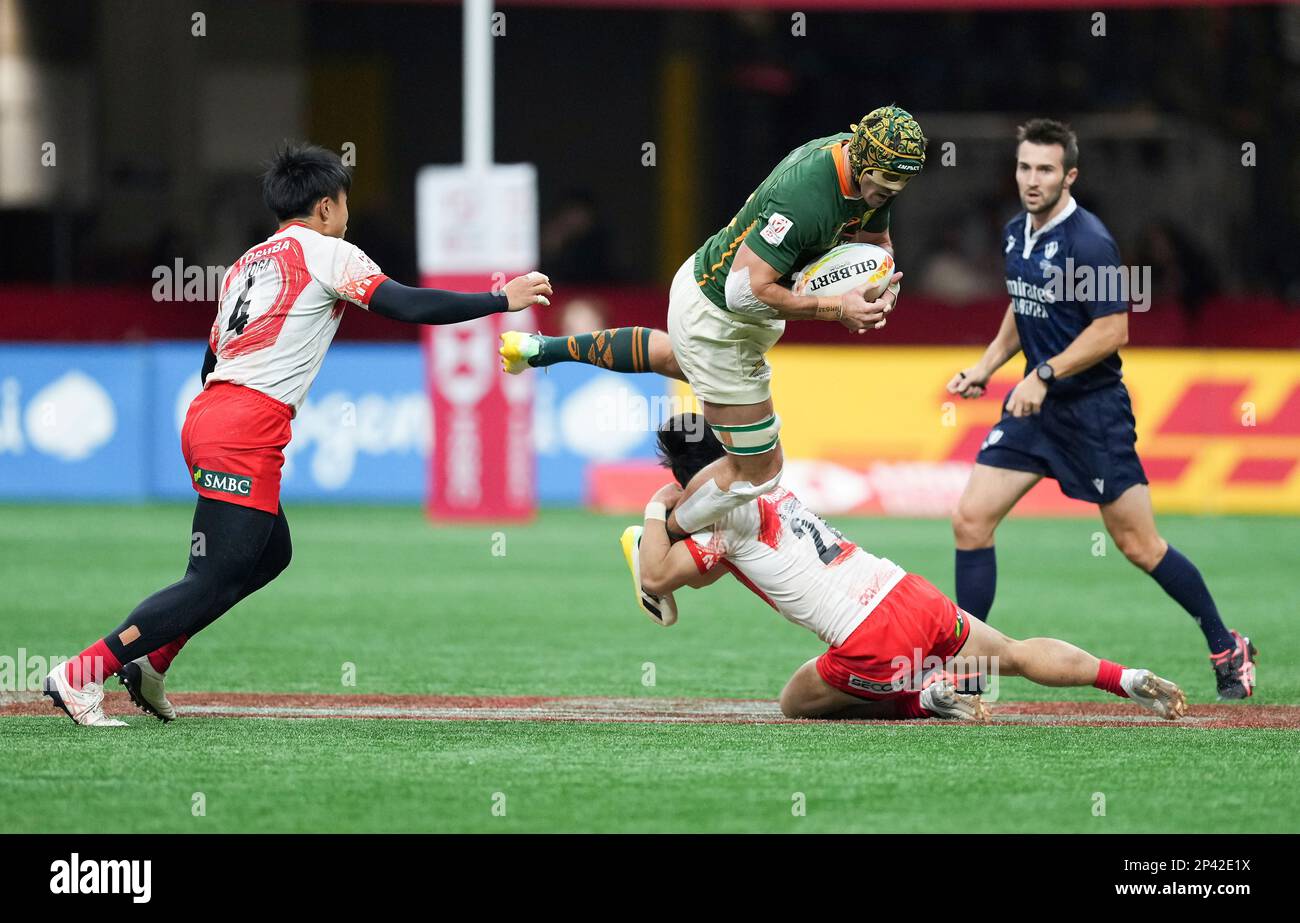 South Africa's Impi Visser, top center, is hit by Japan's Kippei Ishida ...