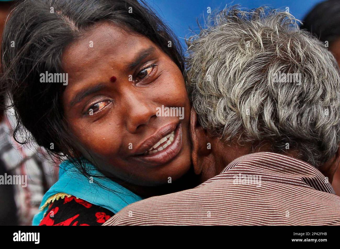 A Sri Lankan mudslide survivor, left, who lost her two daughters is ...