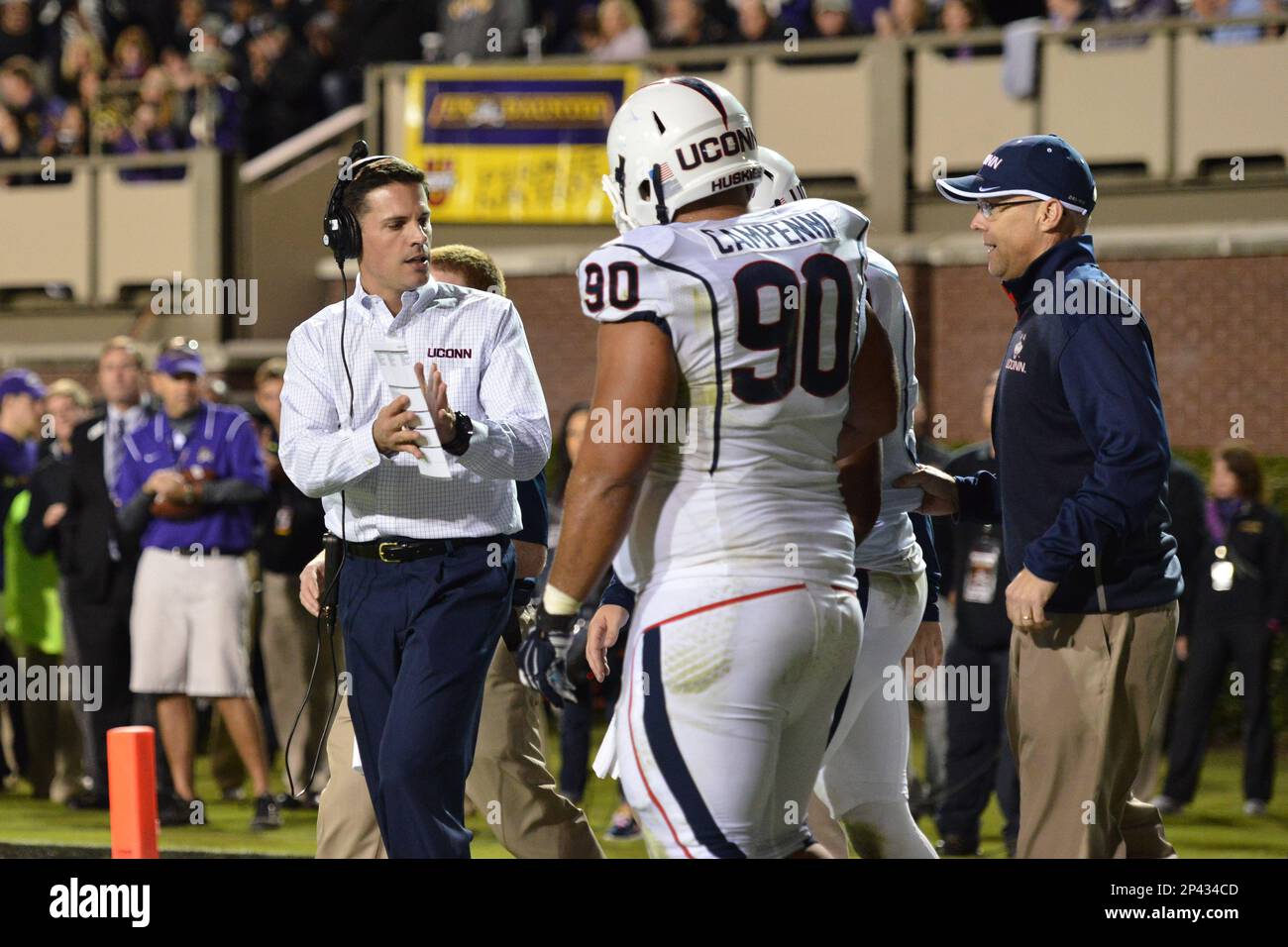 October 23 2014: UConn head coach Bob Diaco checks on an injured player ...